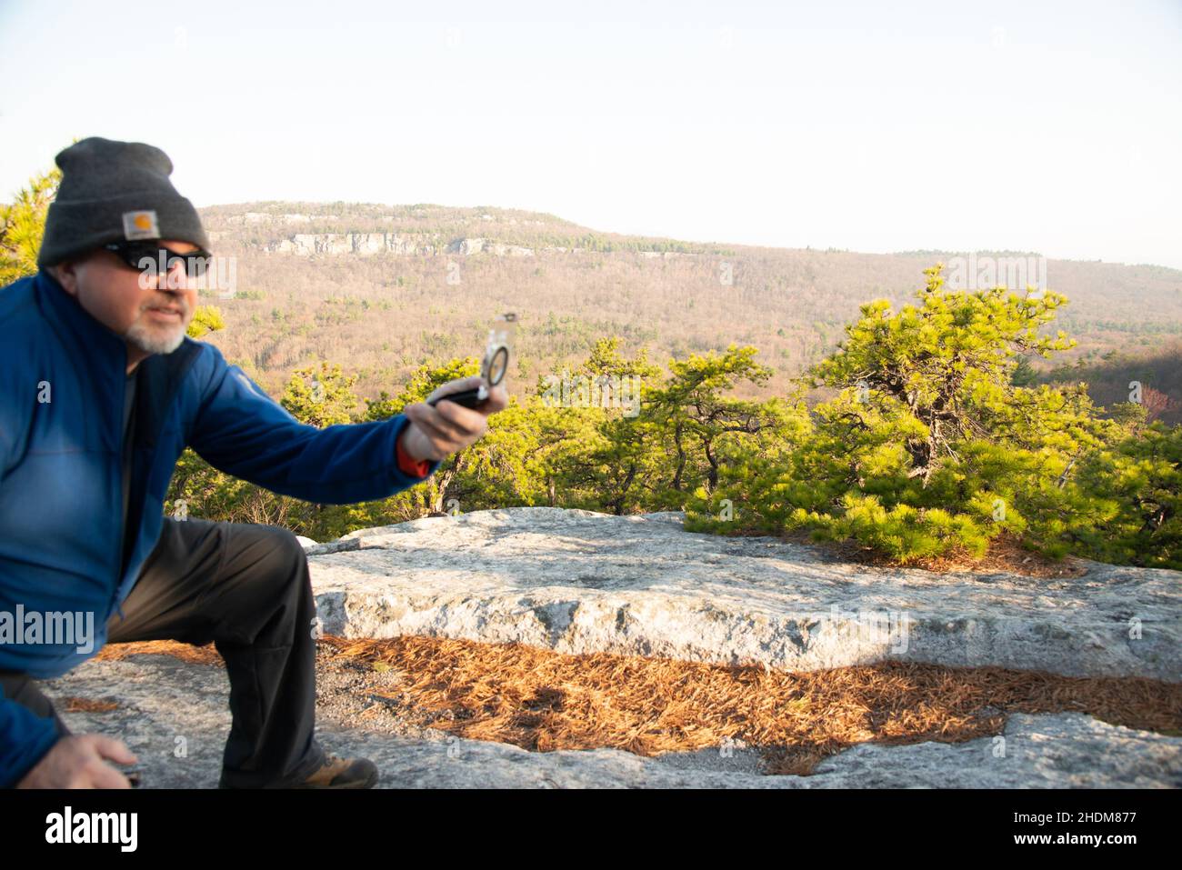 Man hiking with compass Stock Photo - Alamy