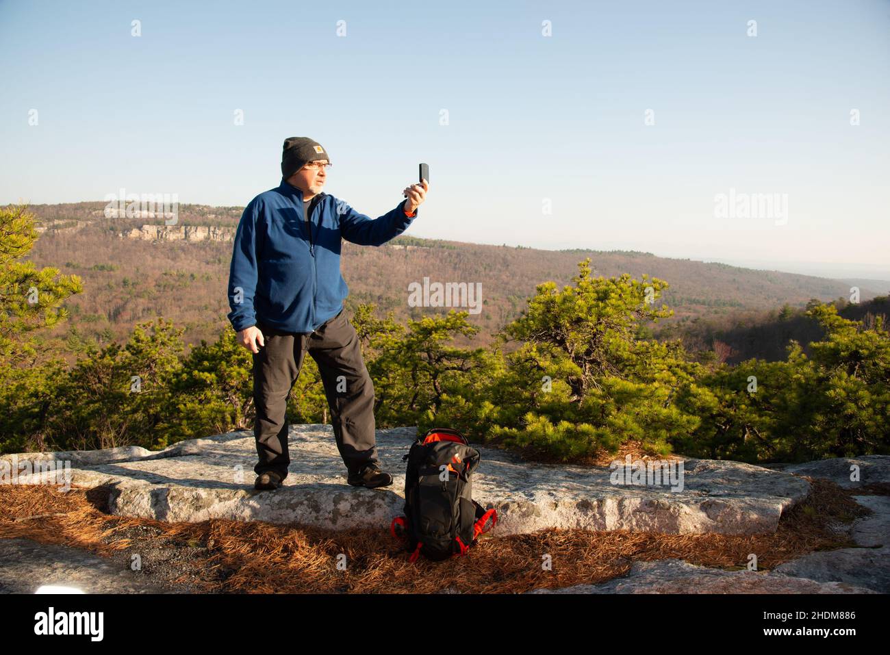 Man hiking with compass Stock Photo - Alamy