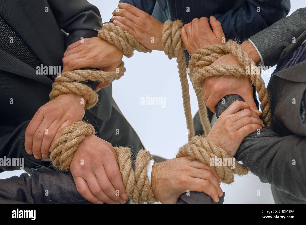 closeup.unified business team ,tied a strong rope Stock Photo - Alamy