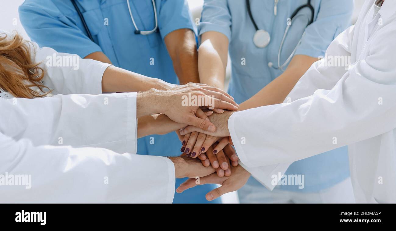 Doctors and nurses stacking hands. concept of mutual aid Stock Photo ...