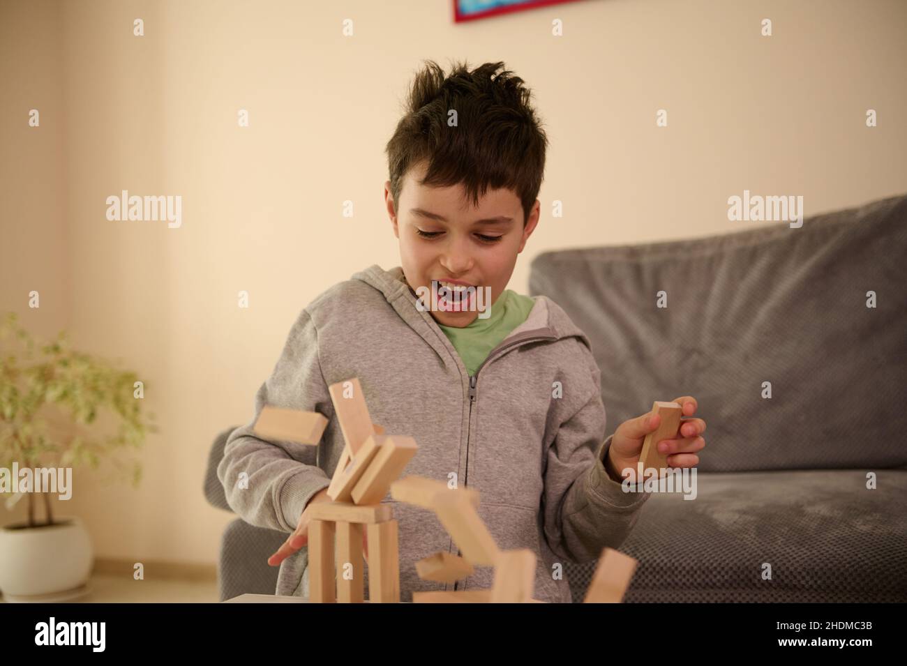Close-up of a handsome school aged Caucasian boy playing board games ...