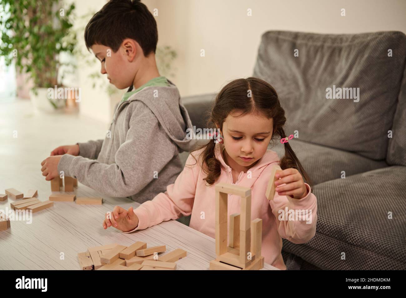 Two Adorable Caucasian Kids Concentrated Children Boy And Girl two-adorable-caucasian-kids-concentrated-children-boy-and-girl
