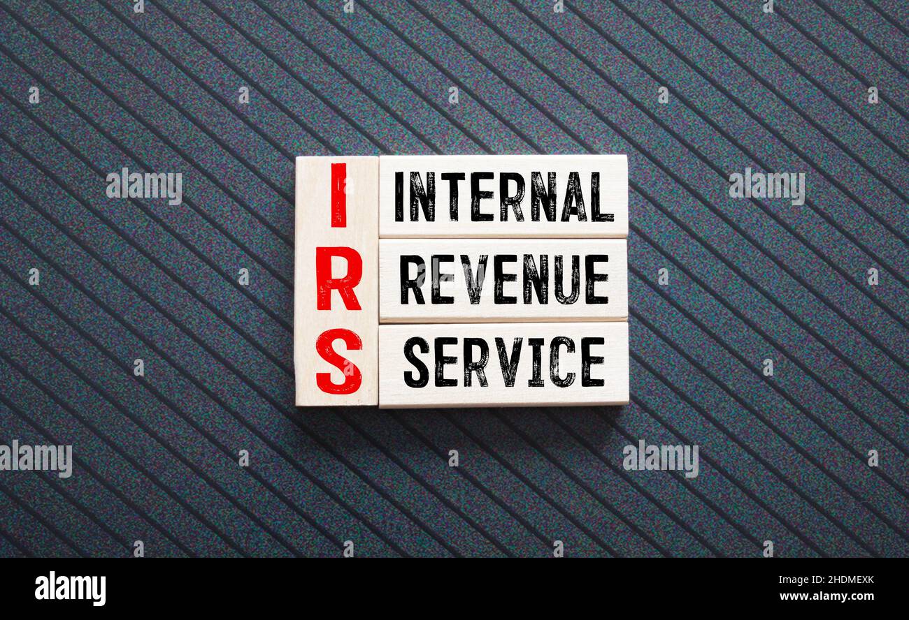 IRS- abbreviation Internal Revenue Service. Written on wooden blocks on ...