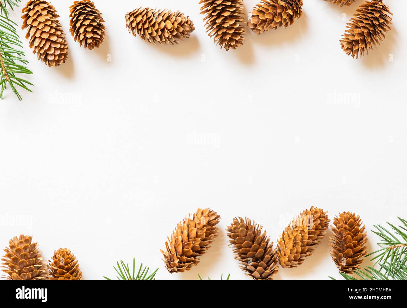 Christmas frame border of pine cones on a white background with copy space for text, evergreen ...
