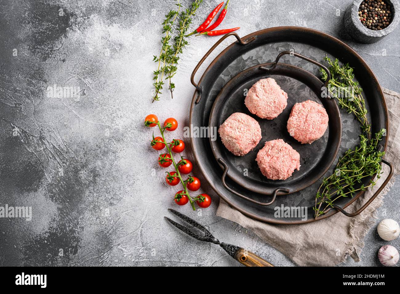 Raw burgers cutlets from organic meat, on gray stone table background ...