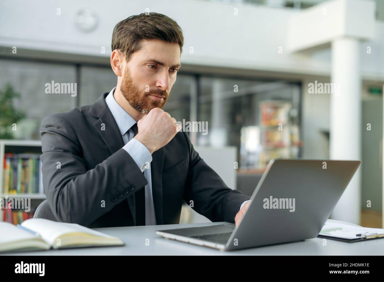 Serious thoughtful business man uses hi-res stock photography and ...