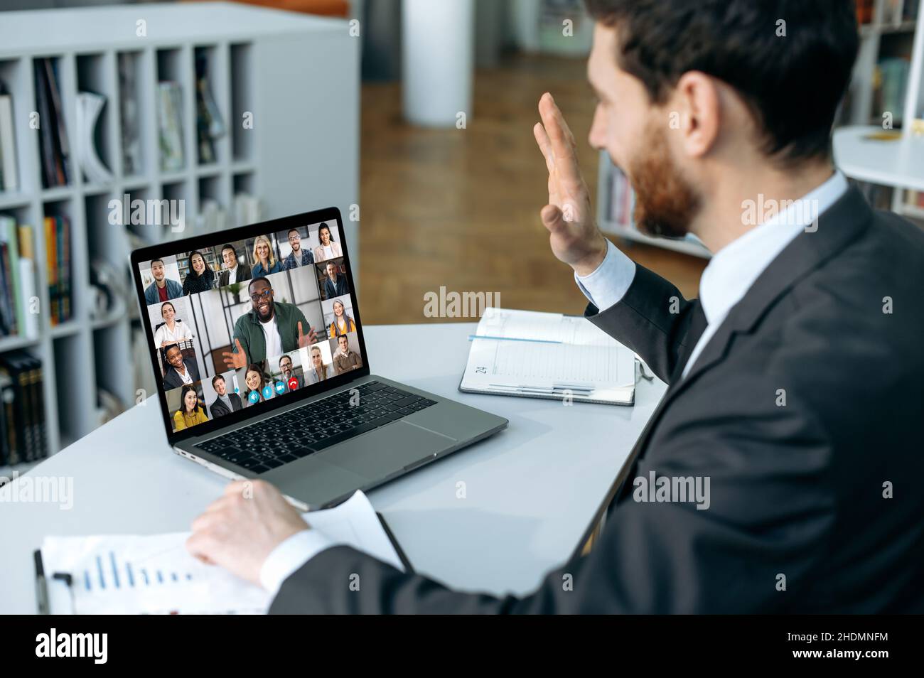 Successful man using a laptop, conducts virtual meeting with business ...