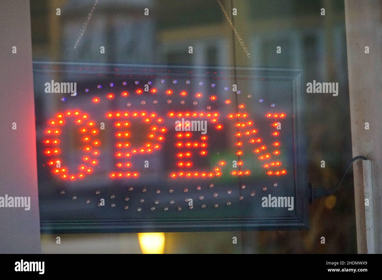 Close up circular red led open sign on a glass door Stock Photo - Alamy