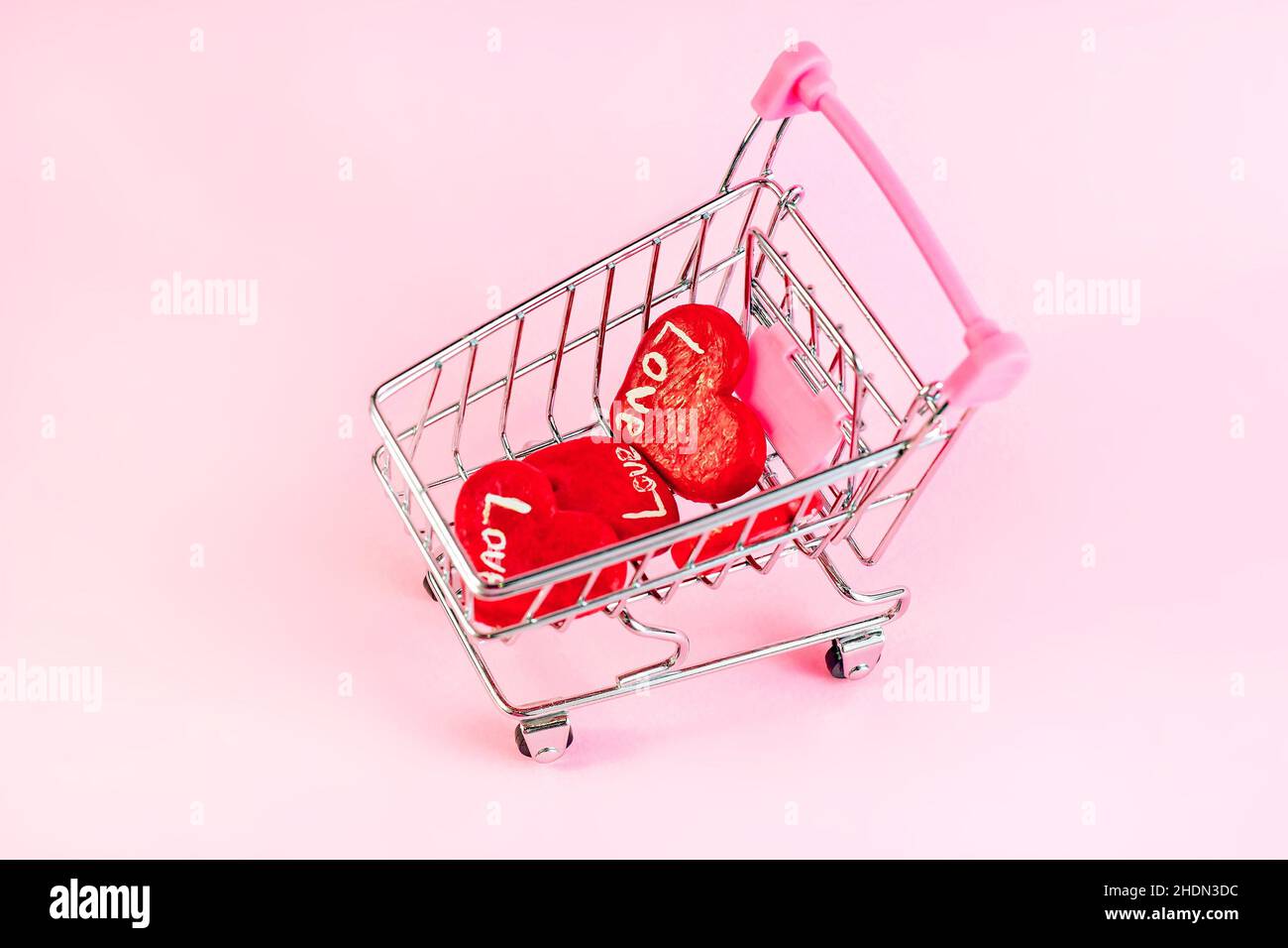 Bright pink shopping trolley push cart with red hearts and Love words ...