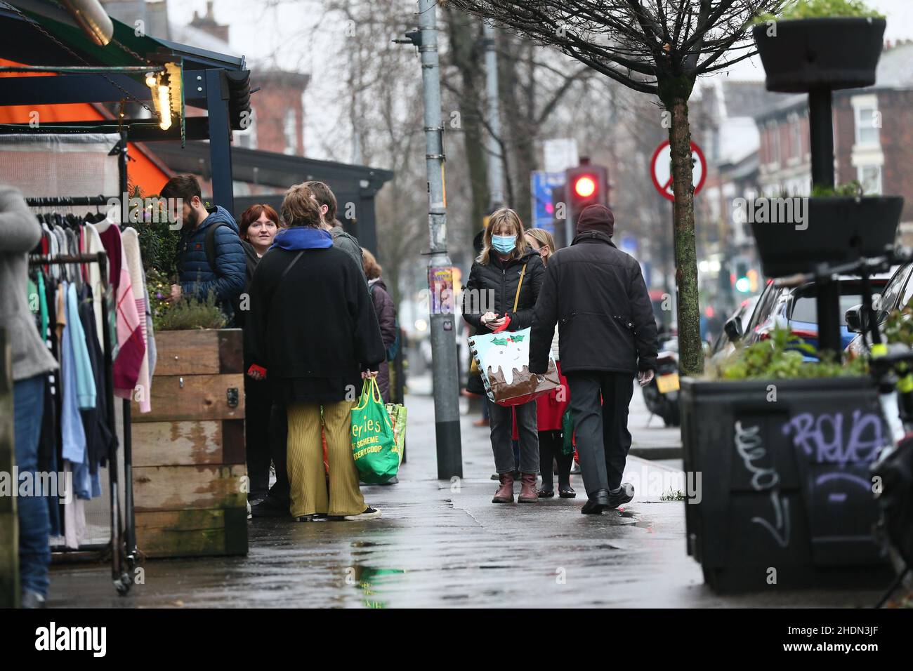 People queue at an upmarket fishmongers in the Manchester suburb of ...