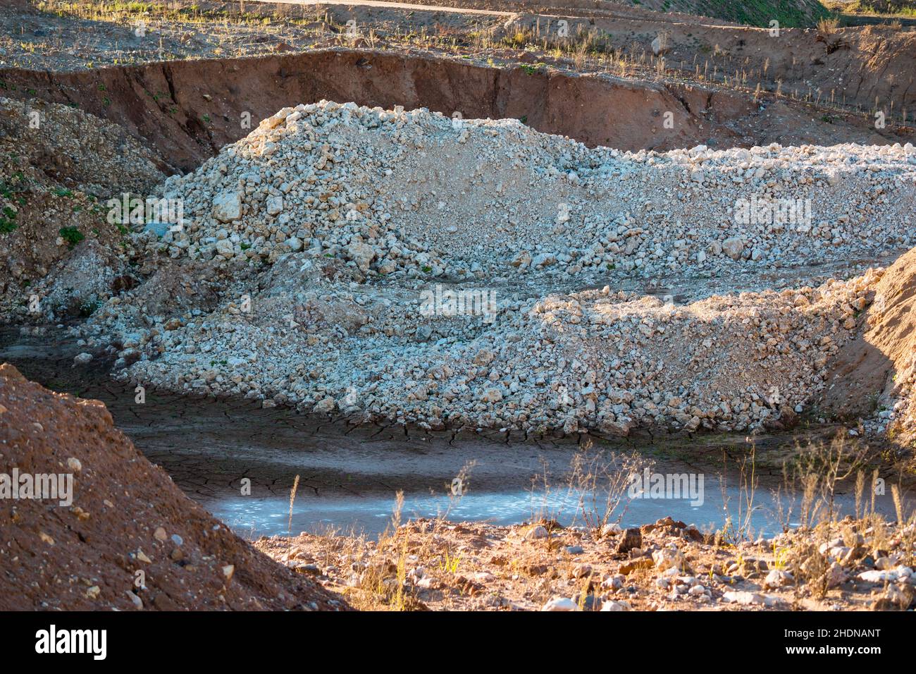 Pit on a stone quarry for the extraction of limestone with a pile of ...