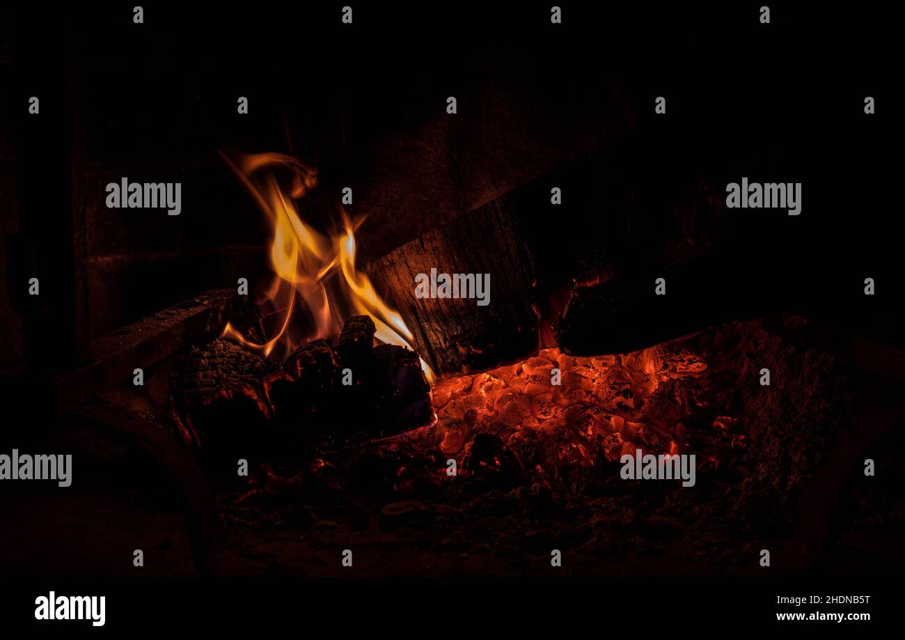 Closeup of a chimney fire and burning coal in the dark Stock Photo - Alamy