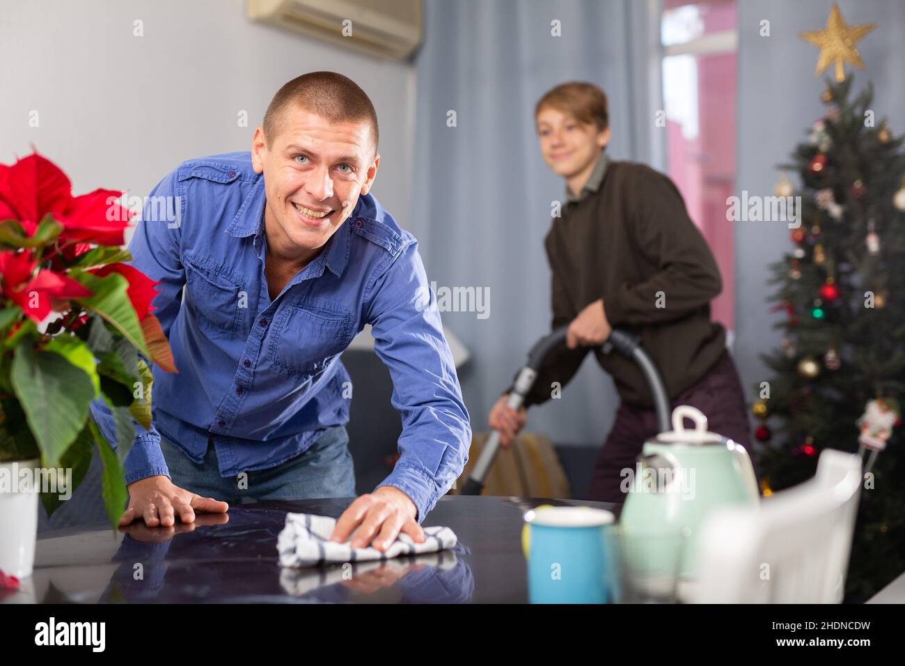 Man wipes the table before Christmas Stock Photo - Alamy