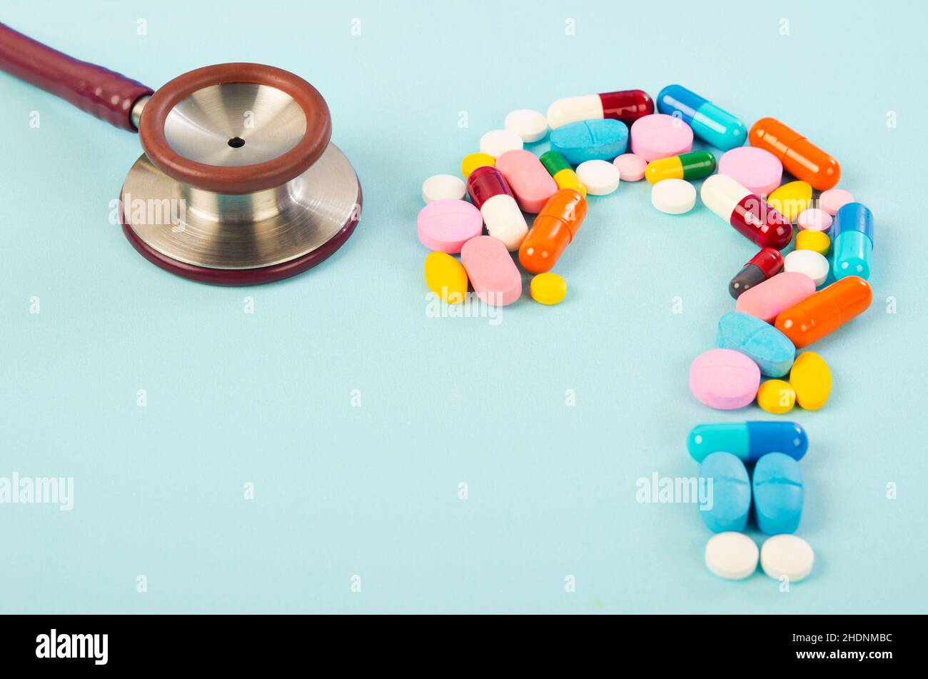 A question mark from laid out of medicine pills with stethoscope on ...
