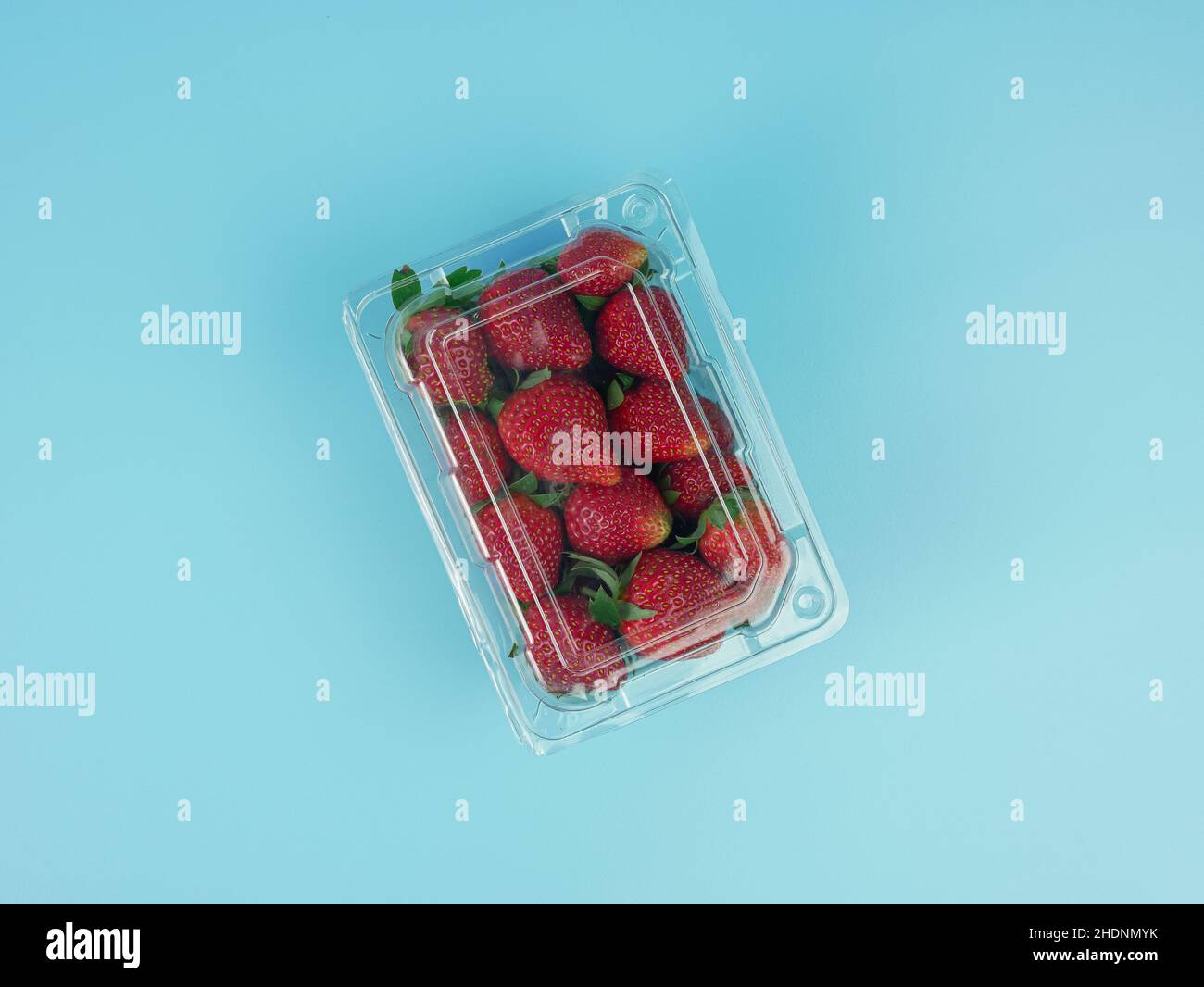 top view of strawberries in a transparent plastic container. healthy ...