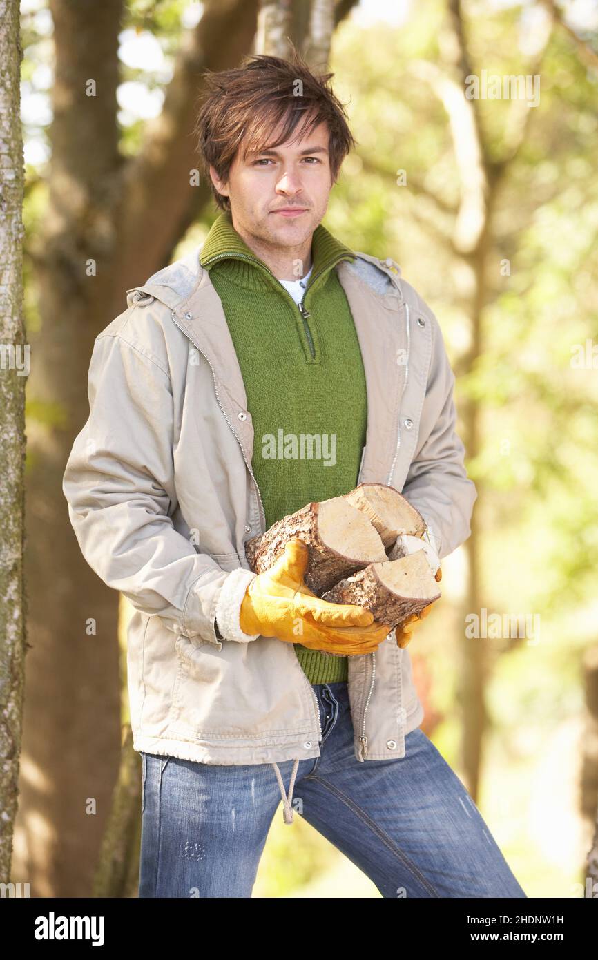 Young man carrying firewood hi-res stock photography and images - Alamy