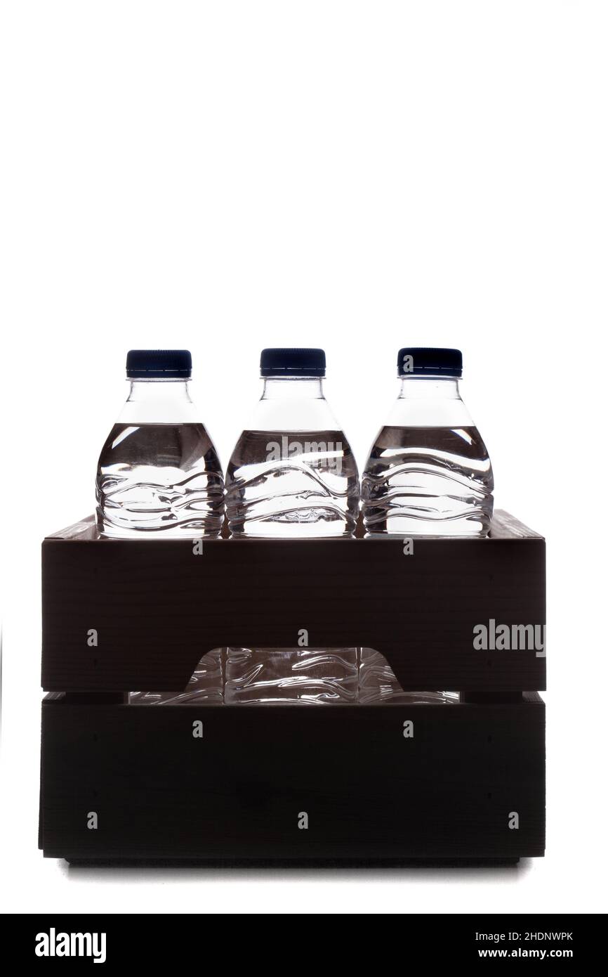 Group of small plastic water bottles in wooden crate. Studio photo ...