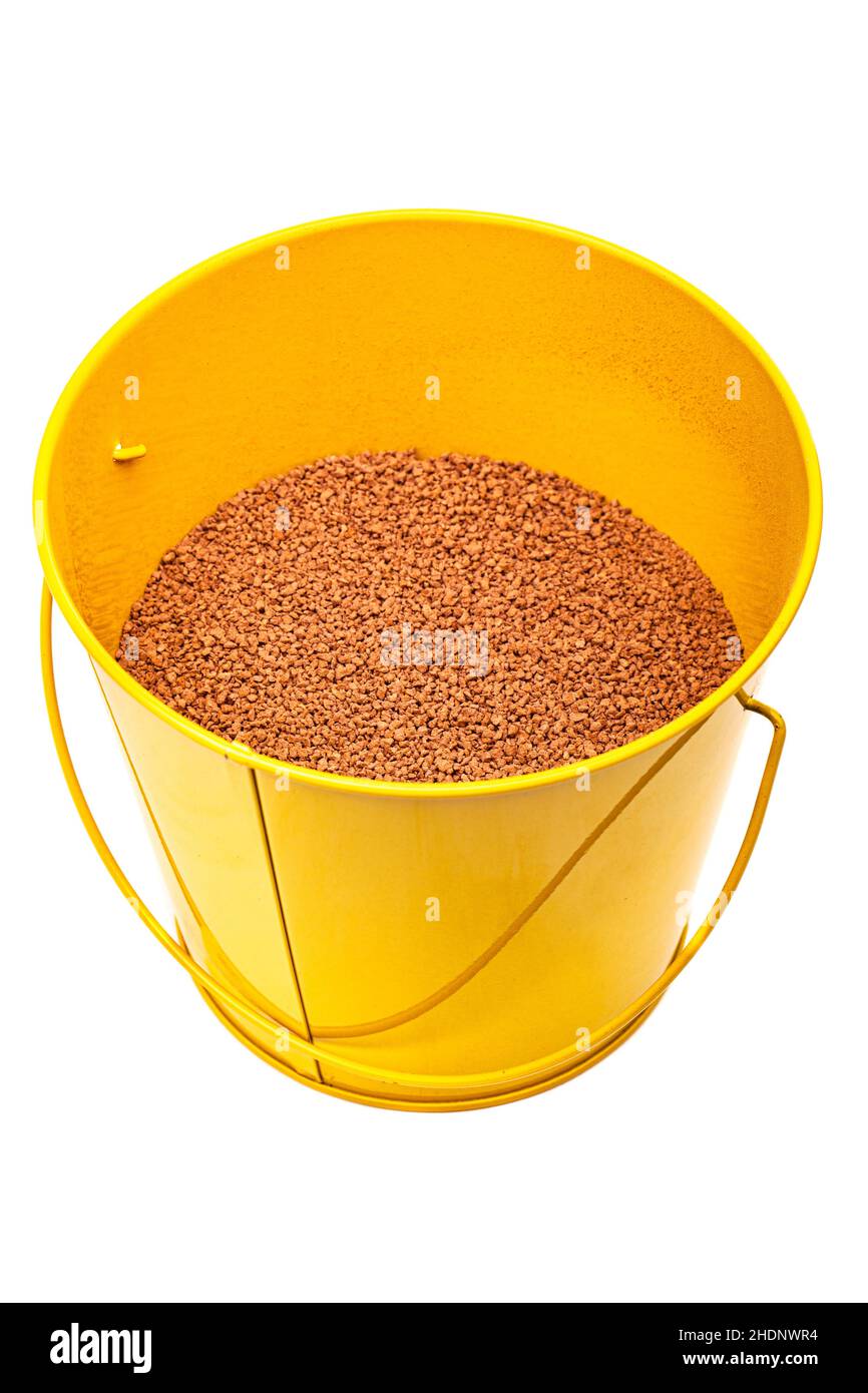 Cocoa powder in small metal yellow bucket isolated on white background ...