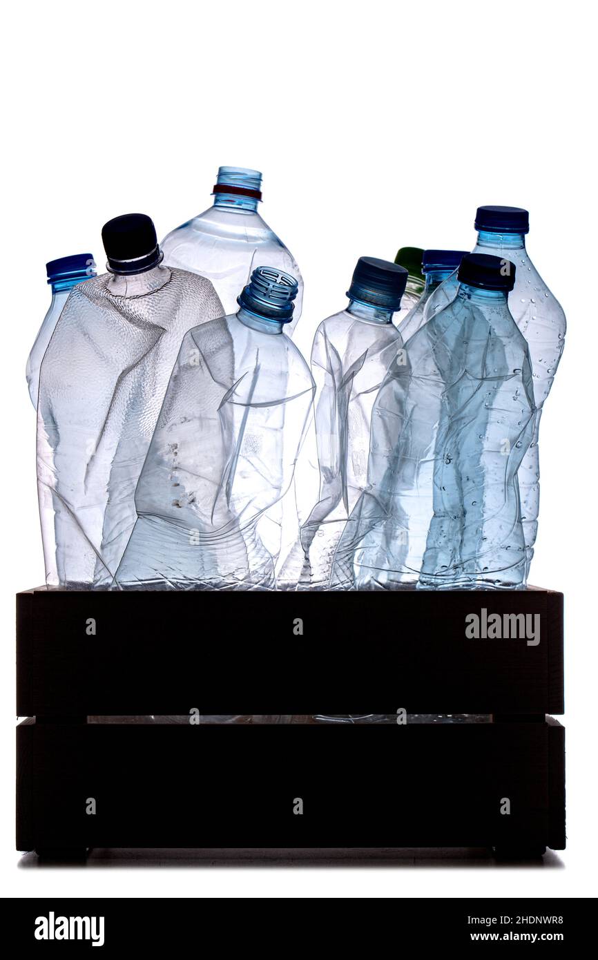 Group of smashed plastic water bottles in wooden crate. Recycle concept ...