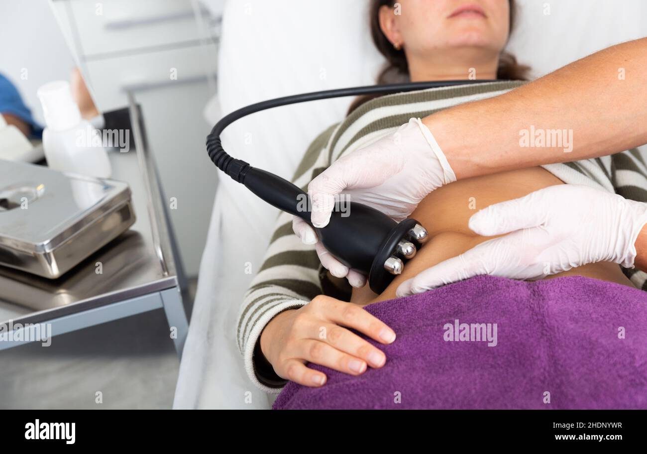 Ultrasonic fat cavitation procedure for female in cosmetology clinic ...