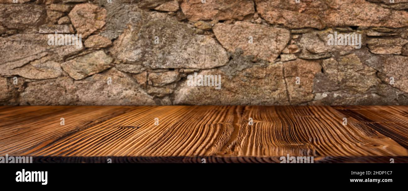 wooden table, stone wall, wooden tables, stone walls Stock Photo - Alamy