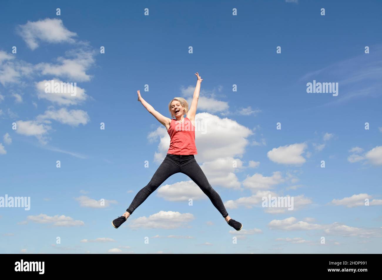 Girl jumping woman blonde blond hi-res stock photography and images - Alamy