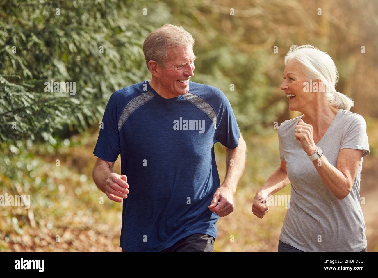 Woman running on path smiling hi-res stock photography and images - Alamy