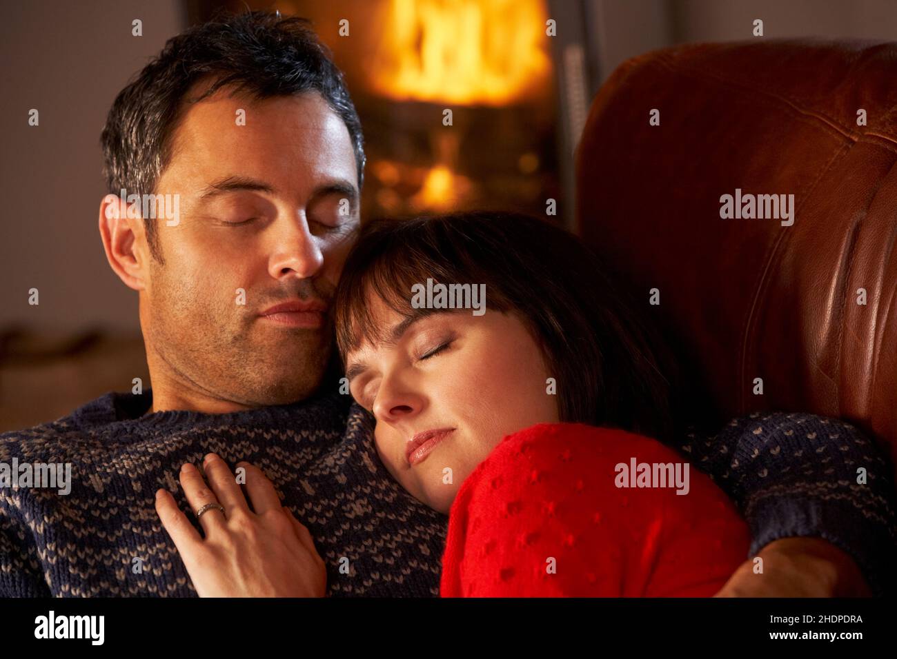 Man sleeping by fireplace hi-res stock photography and images - Alamy