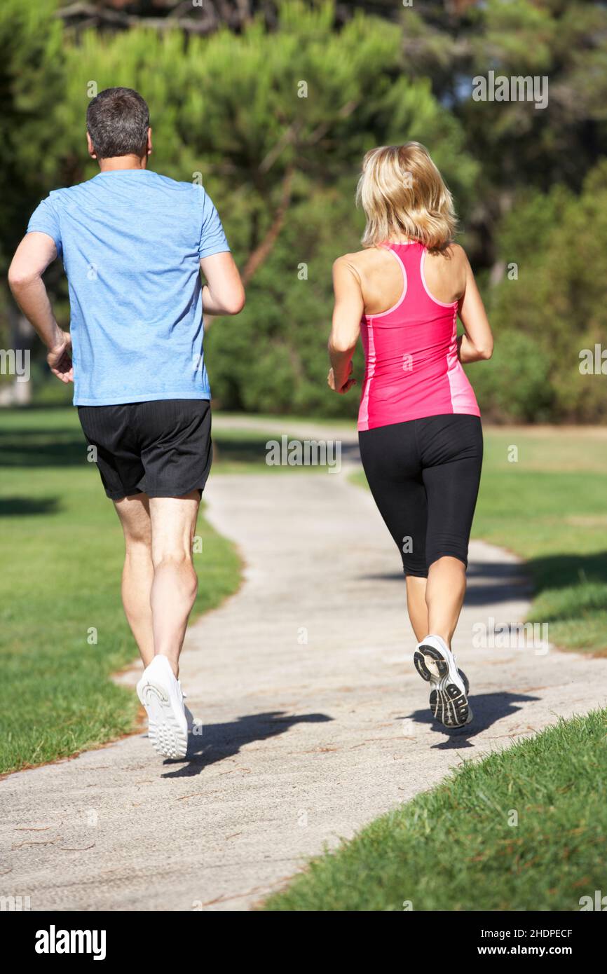 Adult adults man male woman female couple jogger runner runners hi-res ...