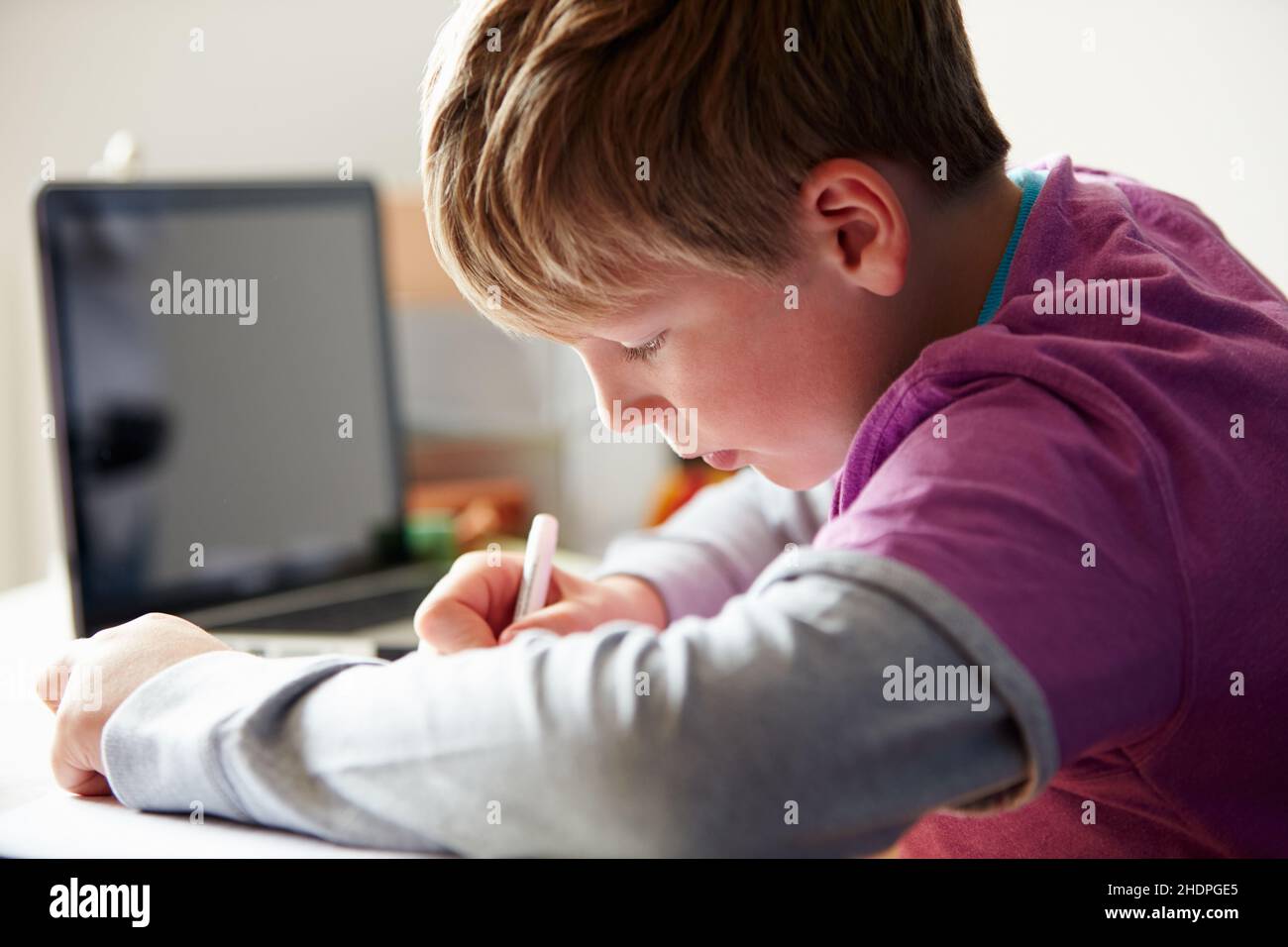 Boy writing homework boys hi-res stock photography and images - Alamy
