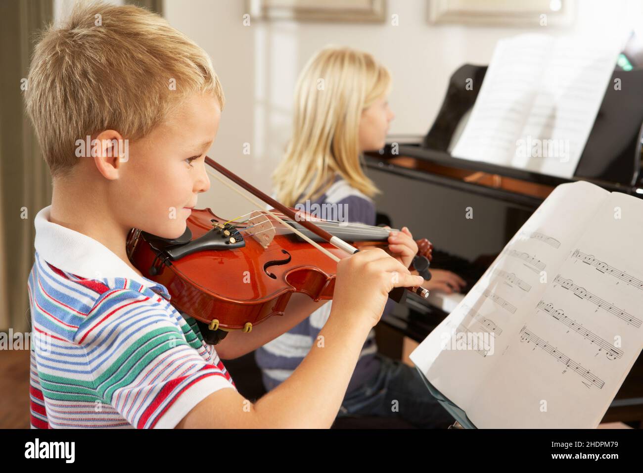 Students playing musical instruments hi-res stock photography and ...