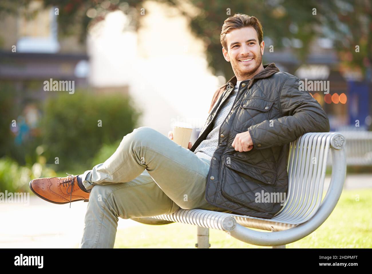 Young man dark hair bench hi-res stock photography and images - Alamy