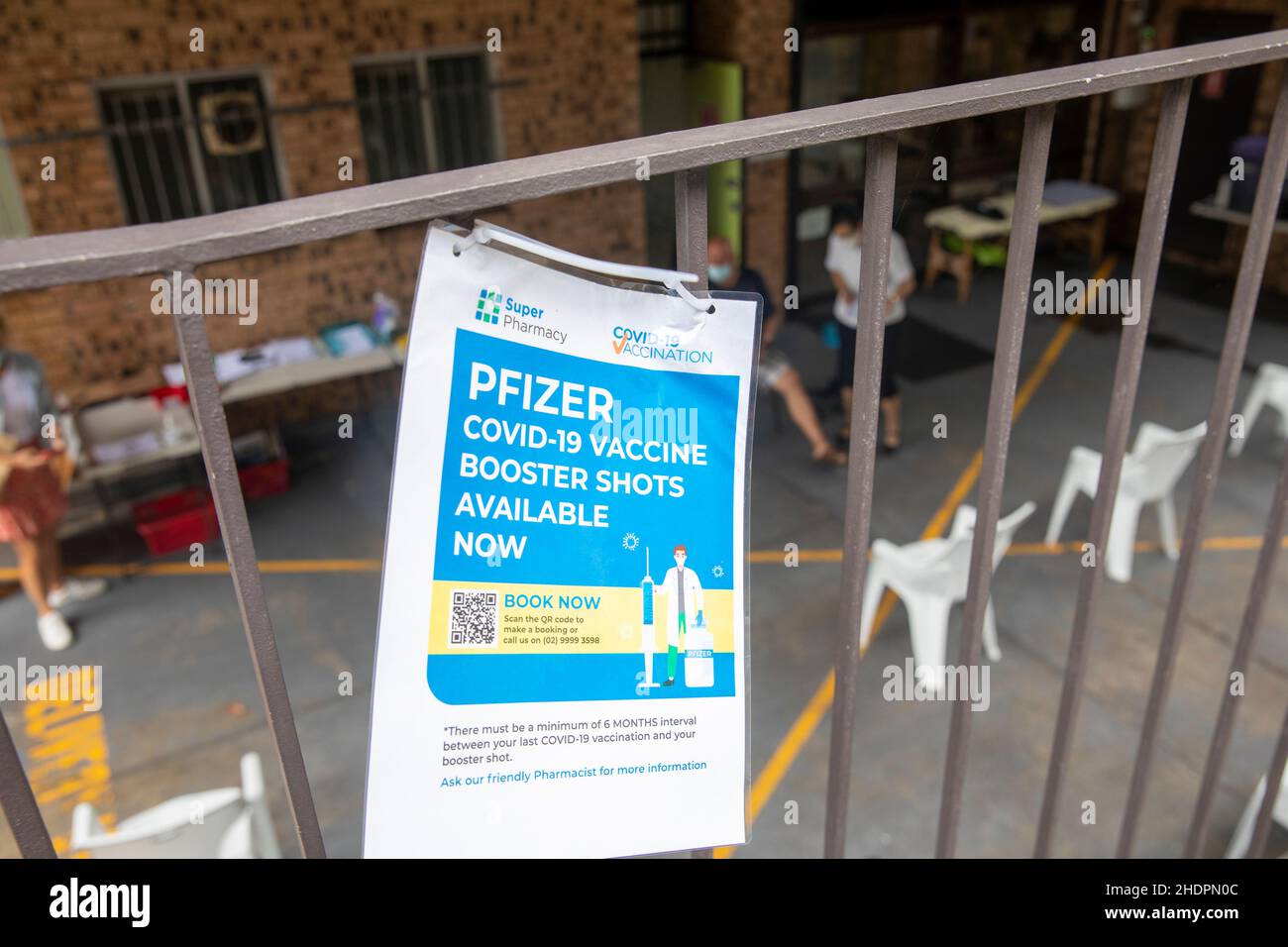 Pfizer booster shots being administered outside a chemist store in ...