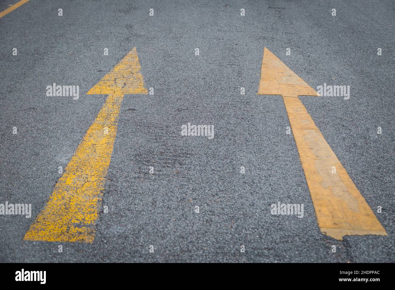 Two yellow arrows old and new directionon asphalt road background Stock ...