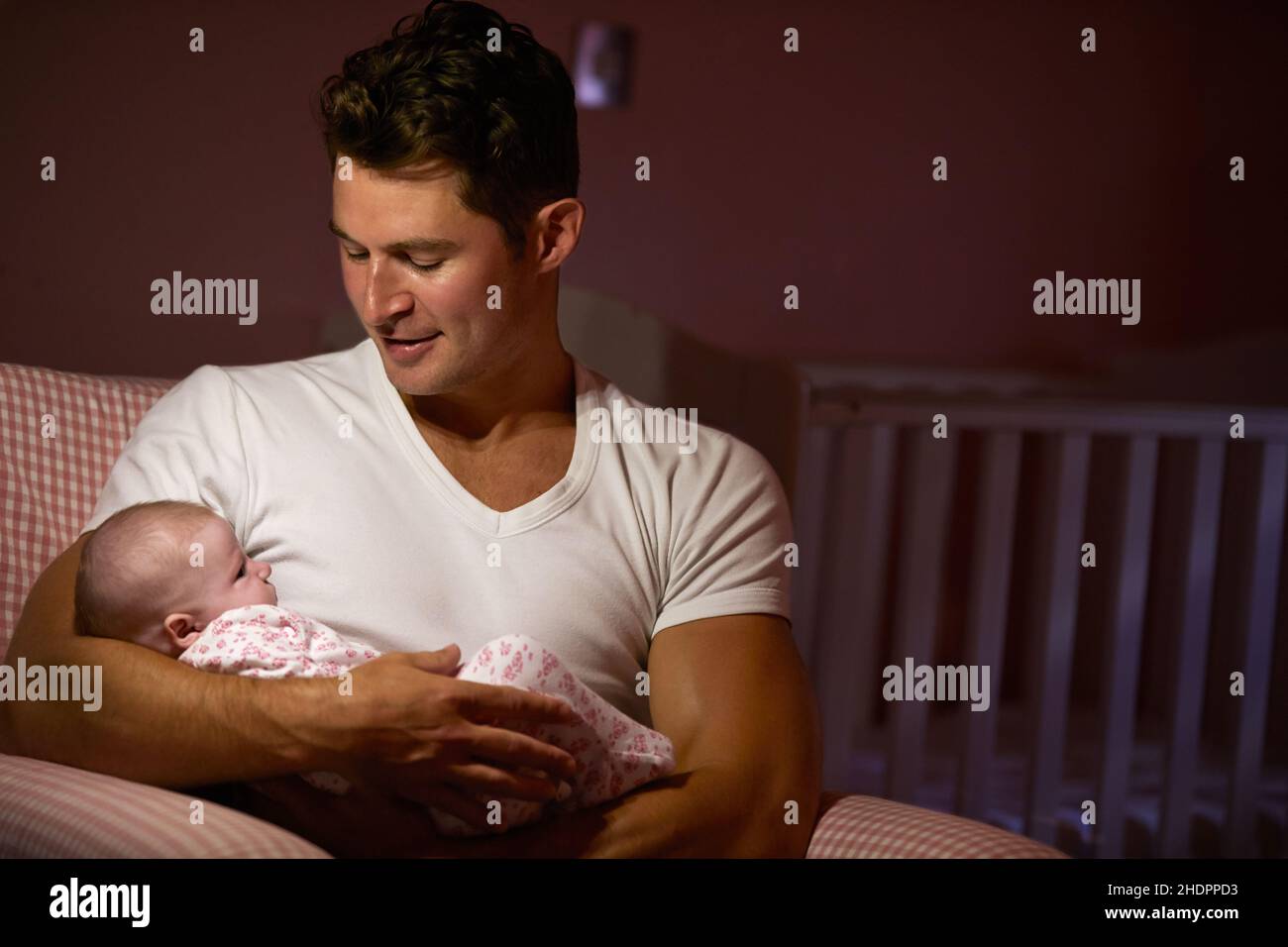Man and babies cot hi-res stock photography and images - Alamy