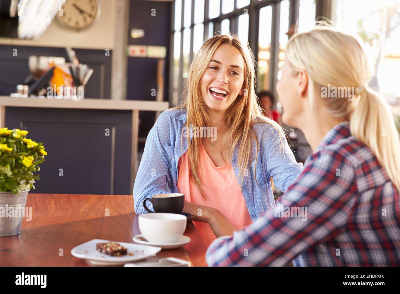 2 female friends laughing cafe hi-res stock photography and images - Alamy