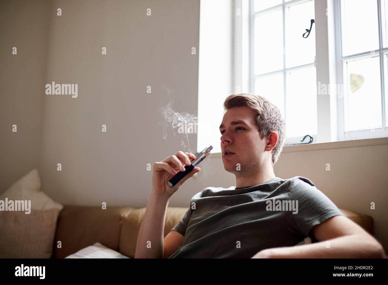 Man smoking cigarette home hi-res stock photography and images - Alamy