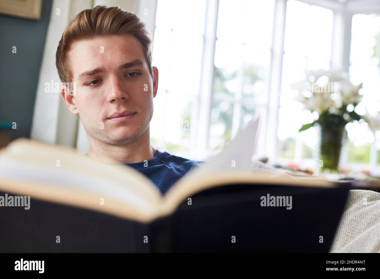 Man reading book young hi-res stock photography and images - Alamy