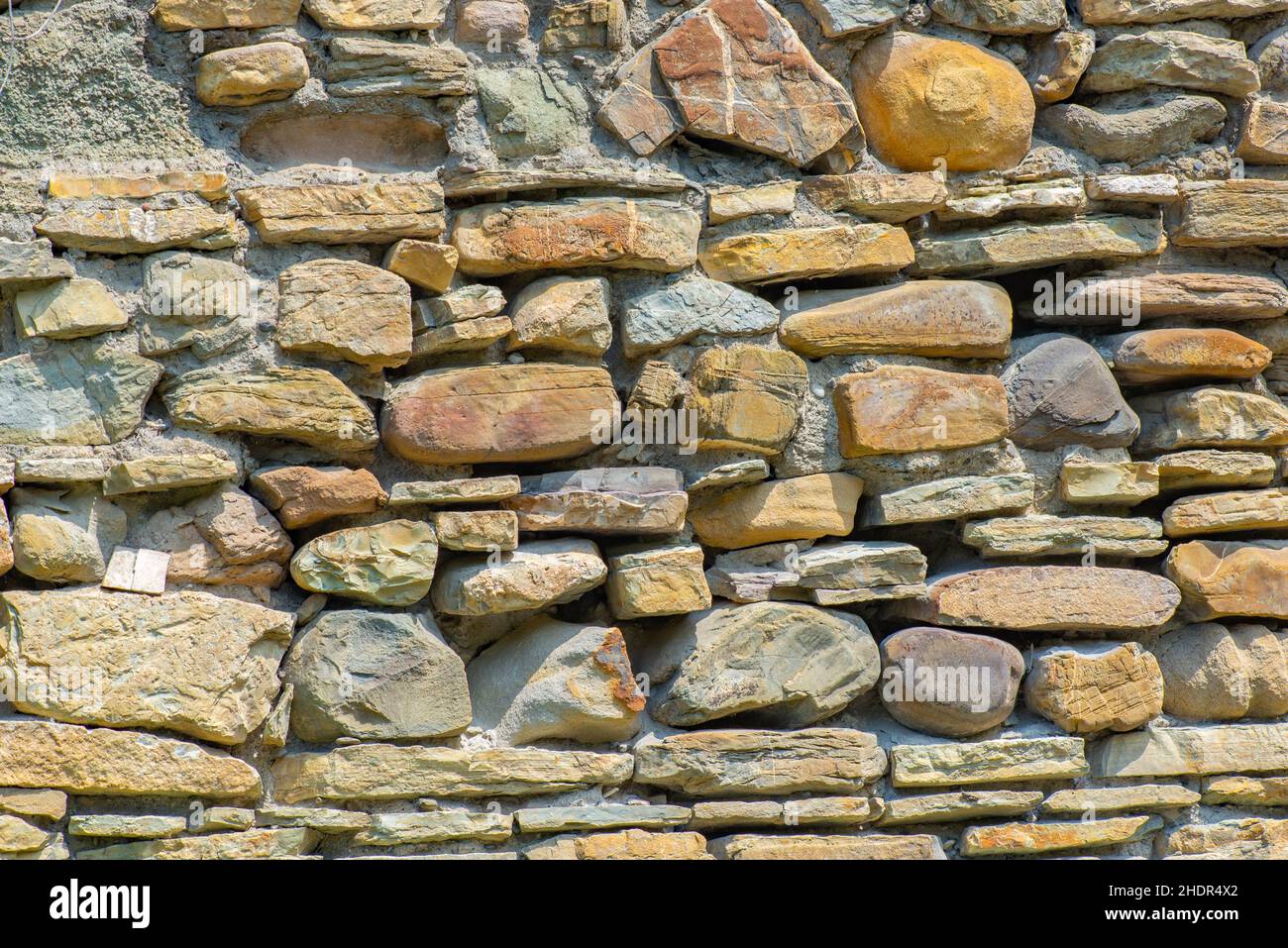 a texture powerful wall of yellow stone Stock Photo - Alamy