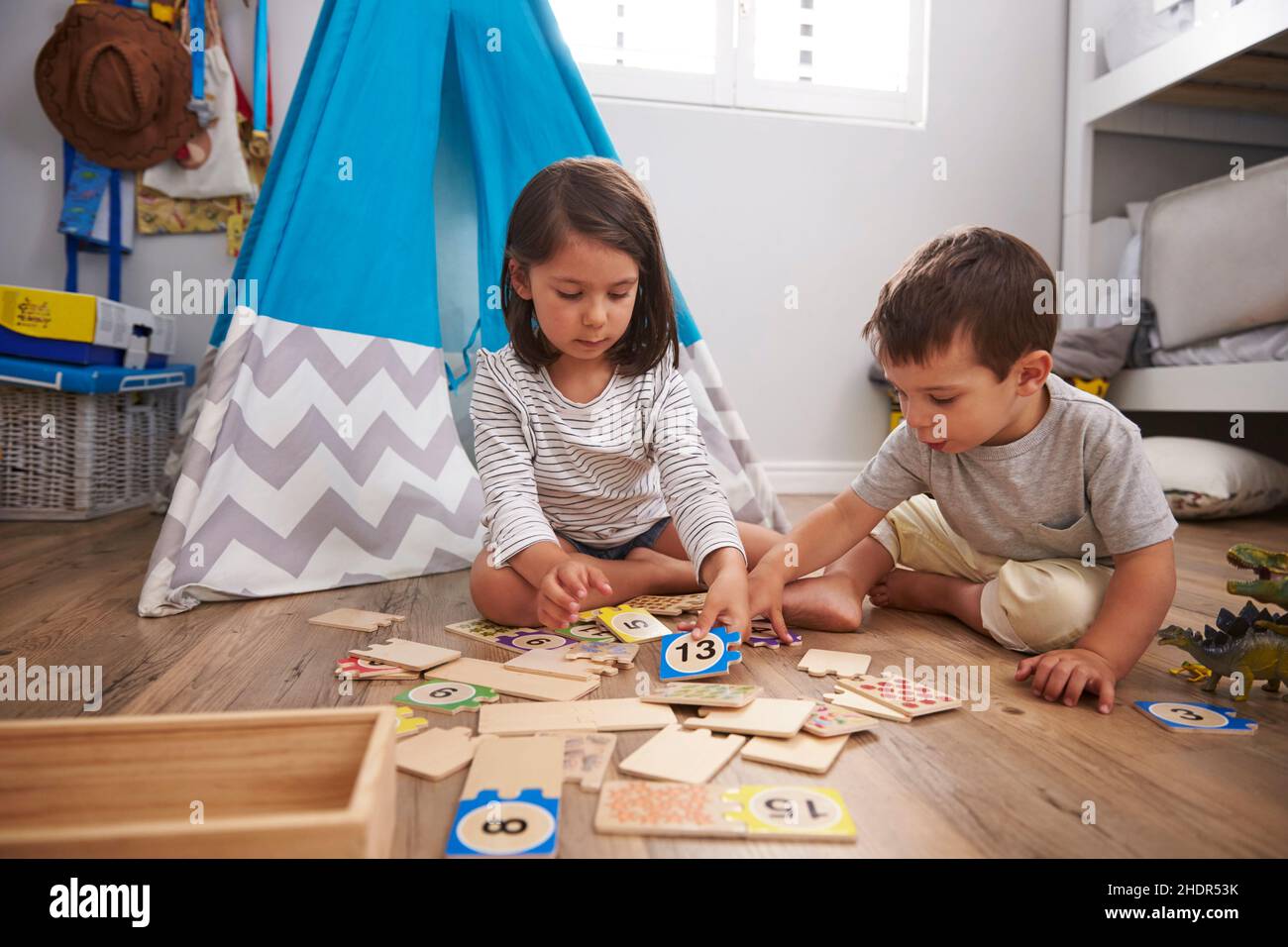 Children playing together jigsaw puzzle hi-res stock photography and ...