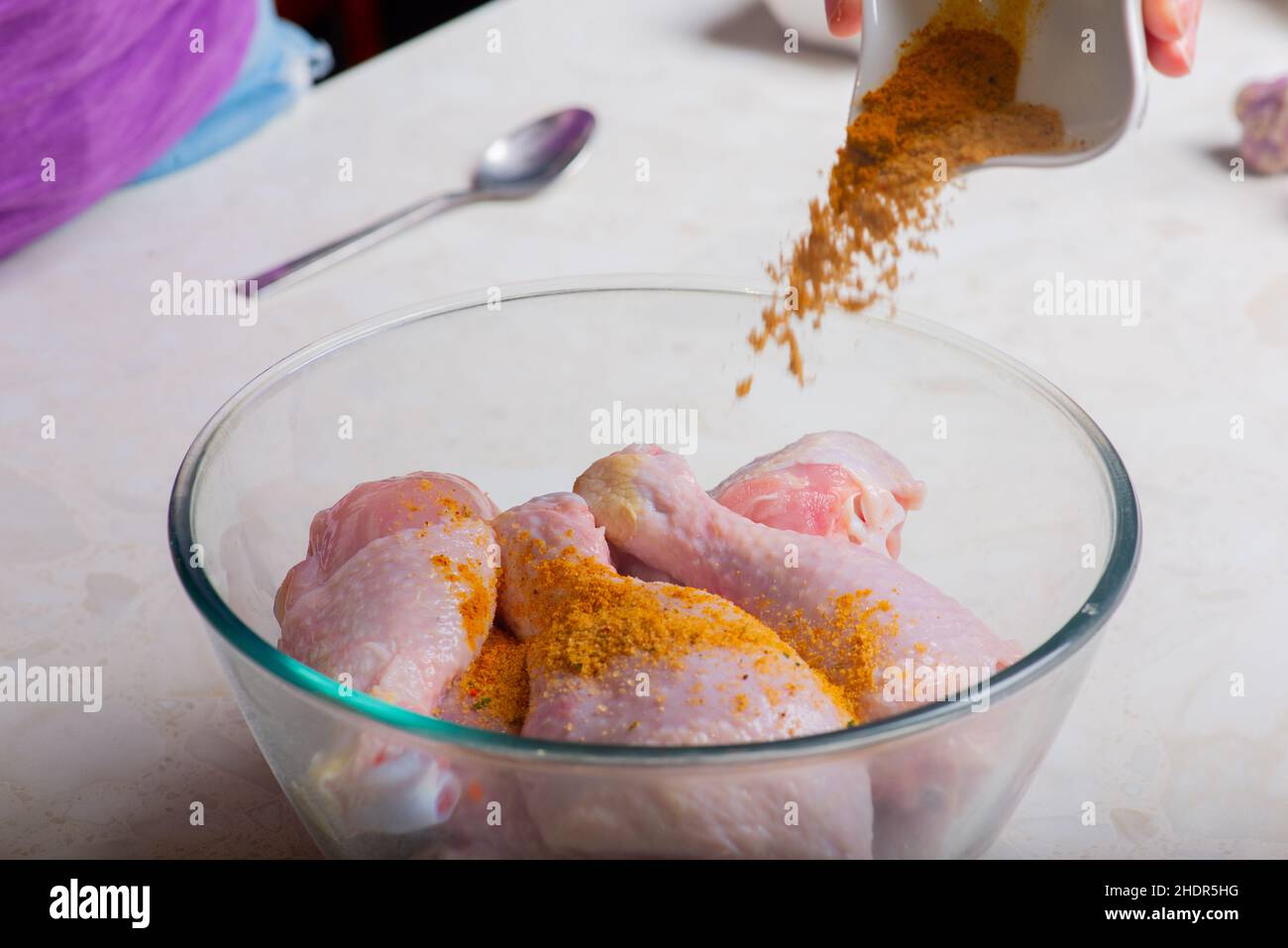 chicken legs in a cup sprinkled with seasoning Stock Photo - Alamy
