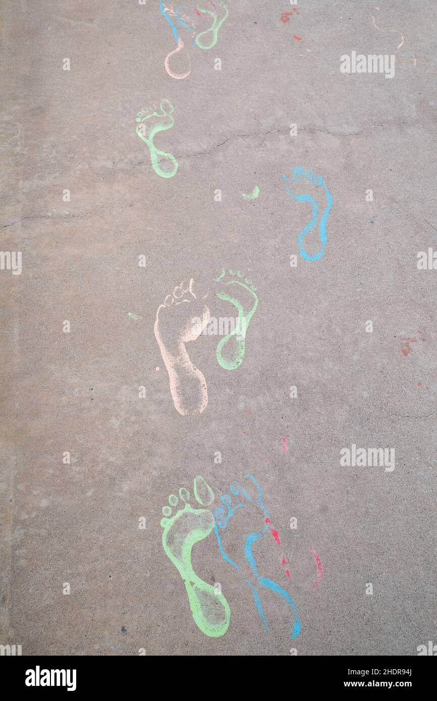 Painted foot prints on footpath Stock Photo - Alamy