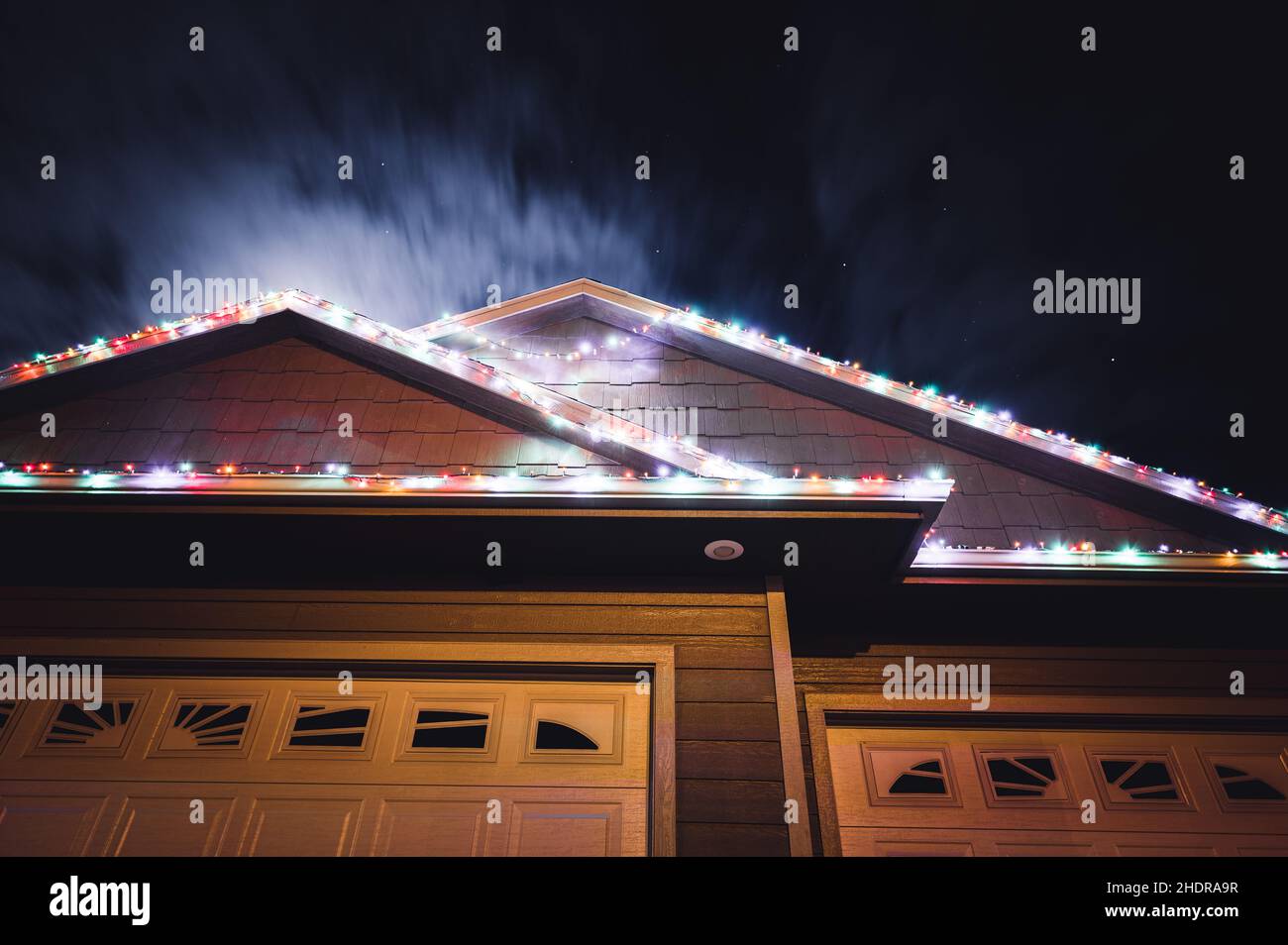 Sagging Christmas lights outdoors on a house that have come loose from ...