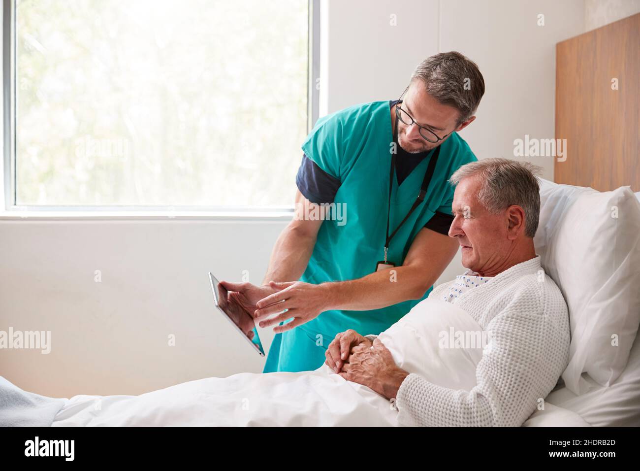 Sick aged patient looking tablet hi-res stock photography and images ...