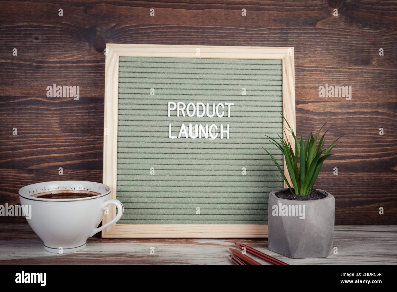 Product Launch. English text on a letter Board. Stationery on a wooden ...