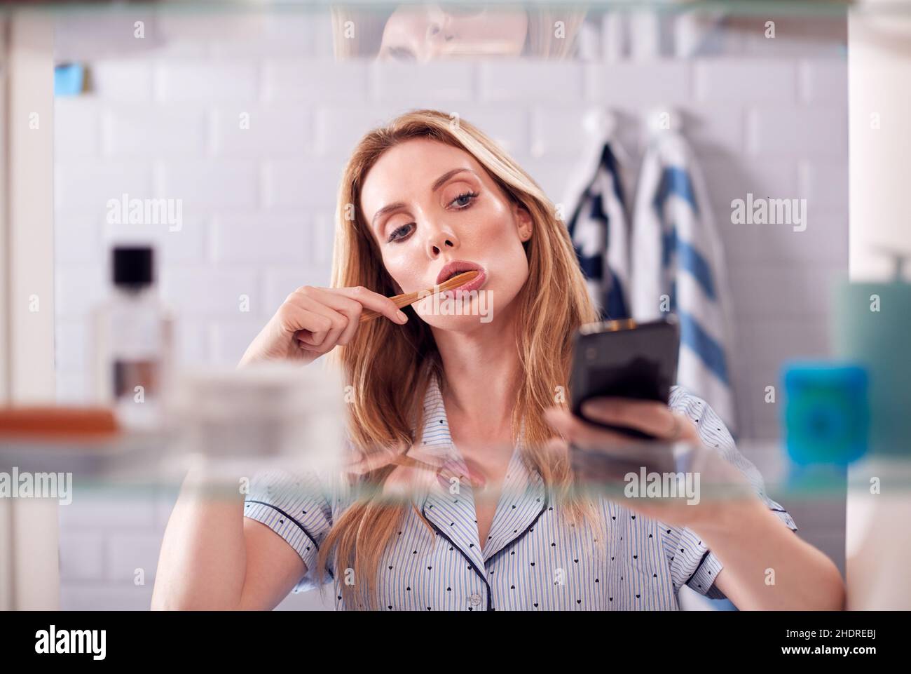 morning, sms, teeth brushing, multi tasking Stock Photo - Alamy