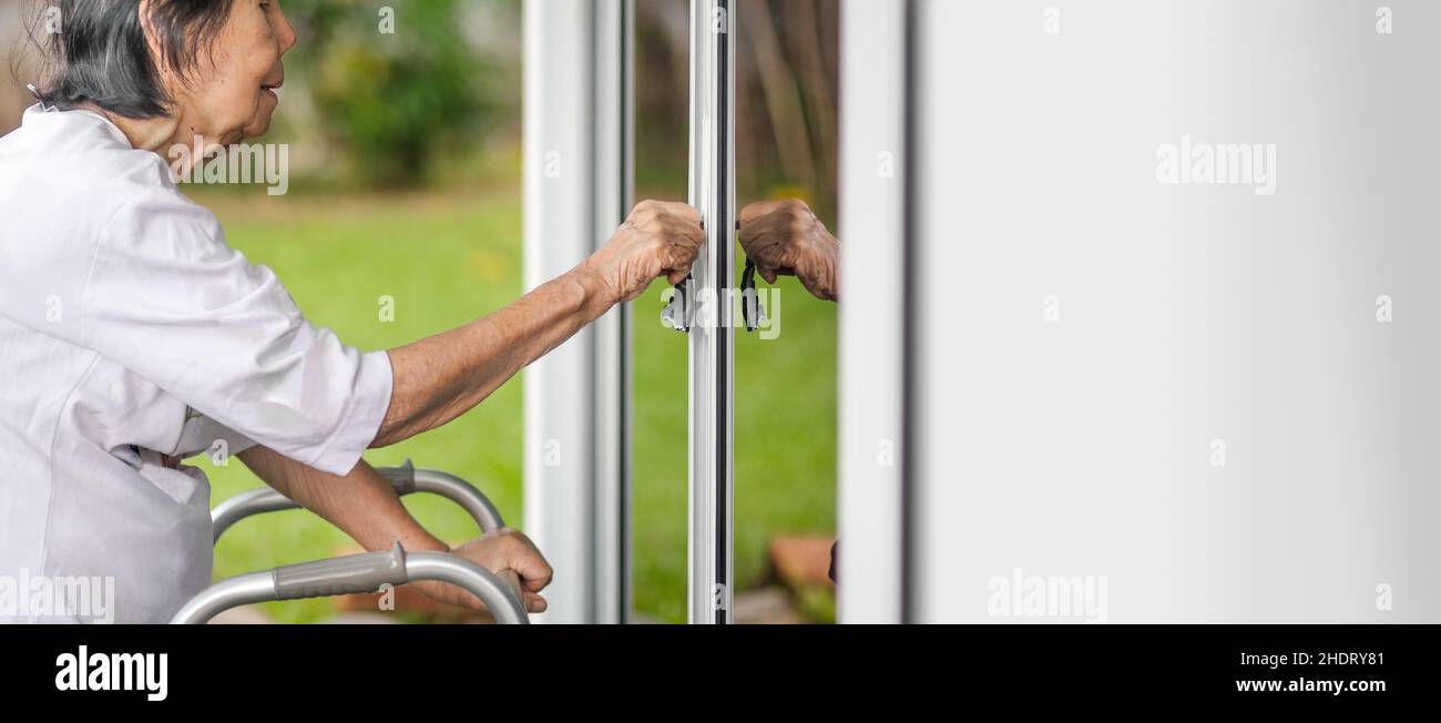 Elderly woman opening door hi-res stock photography and images - Alamy