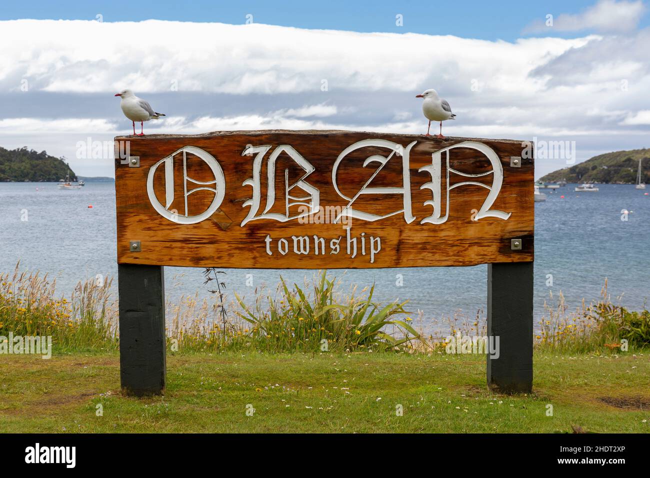 The town sign of Oban sits on the beachfront, and on top of the sign ...