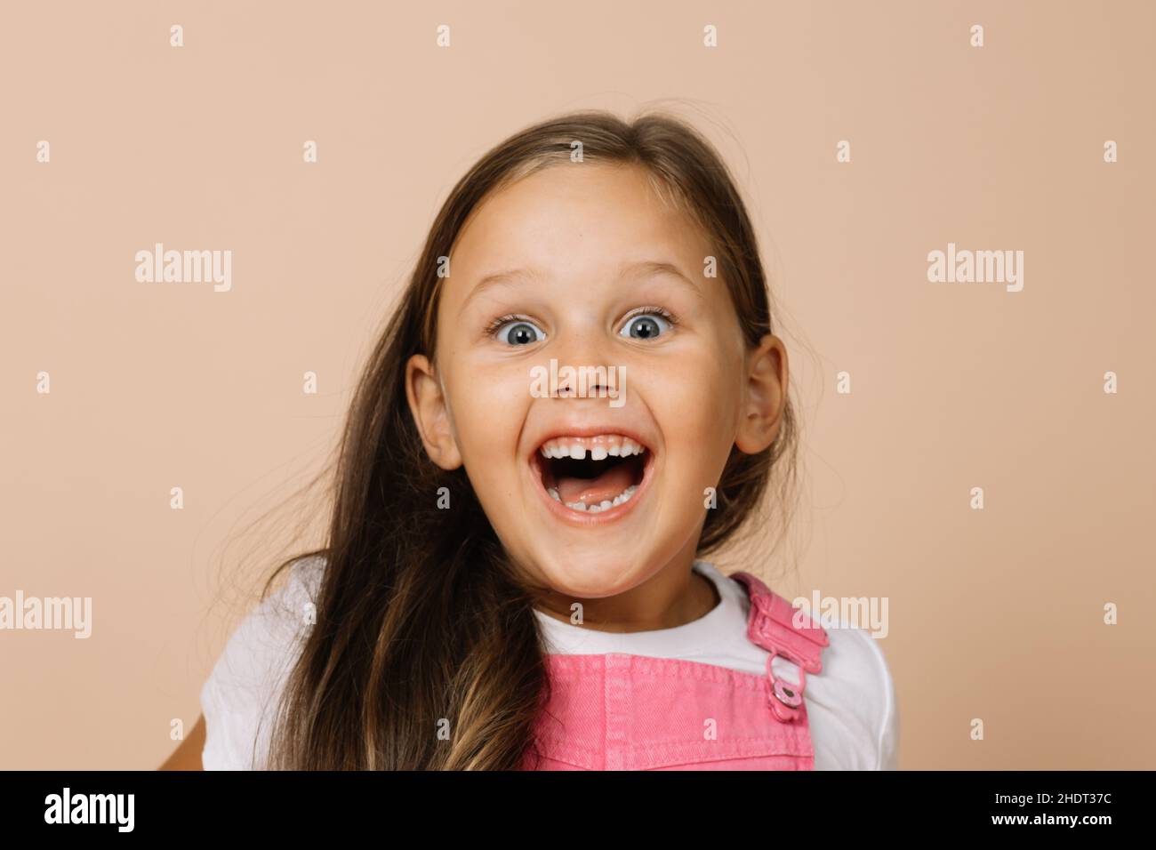Close-up face kid with shining eyes and overexcited smile with teeth ...