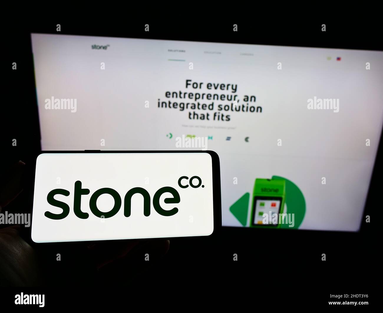 Person holding smartphone with logo of Brazilian fintech business Stone ...